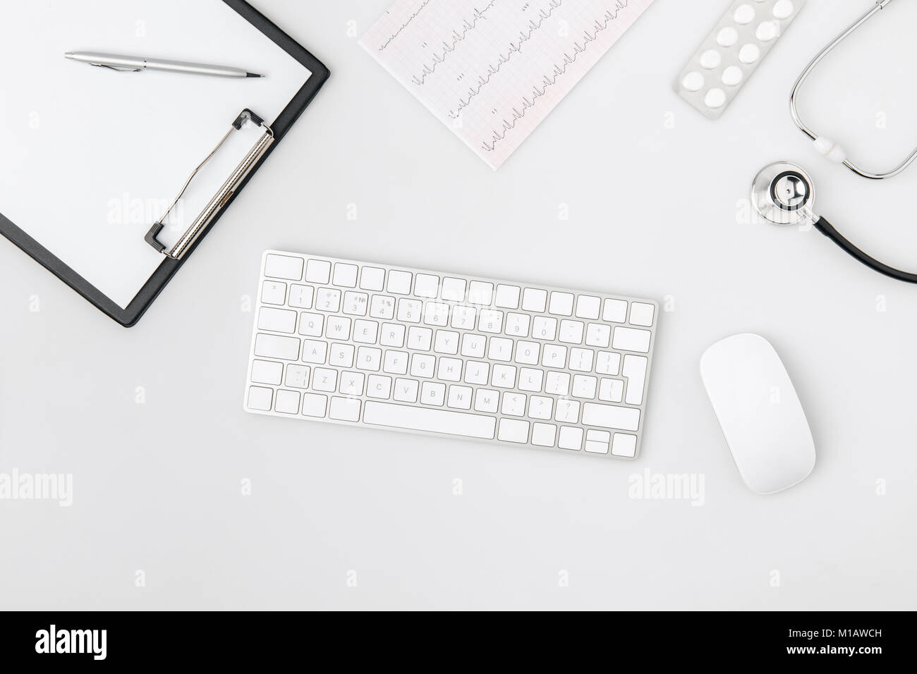 keyboard surrounded by paper in folder, computer mouse, stethoscope ...