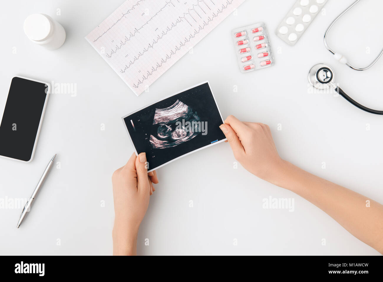 top view of hand holding photo with internal organ screening isolated ...