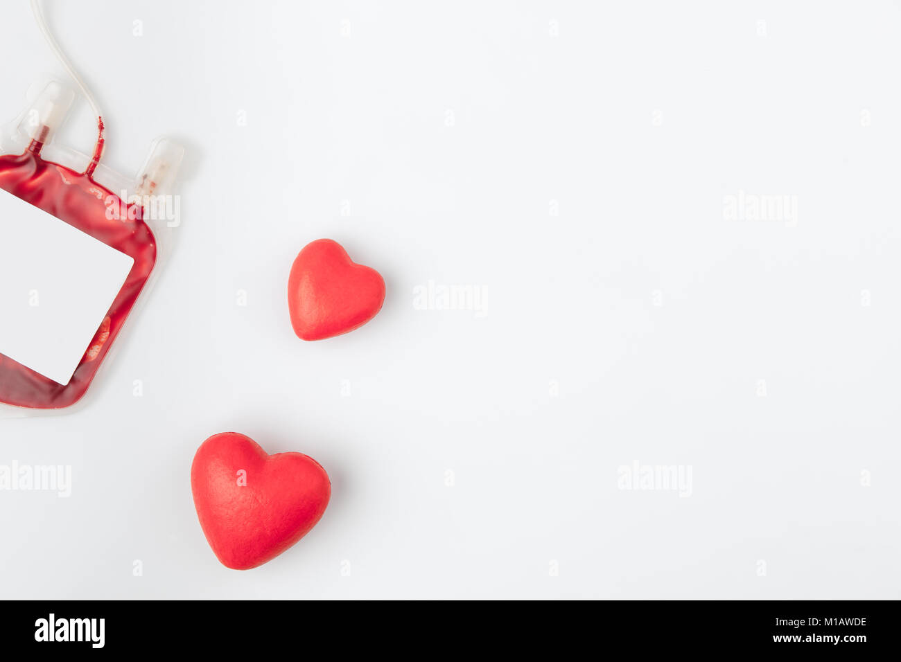 two red hearts near plastic package with blood for transfusion isolated ...