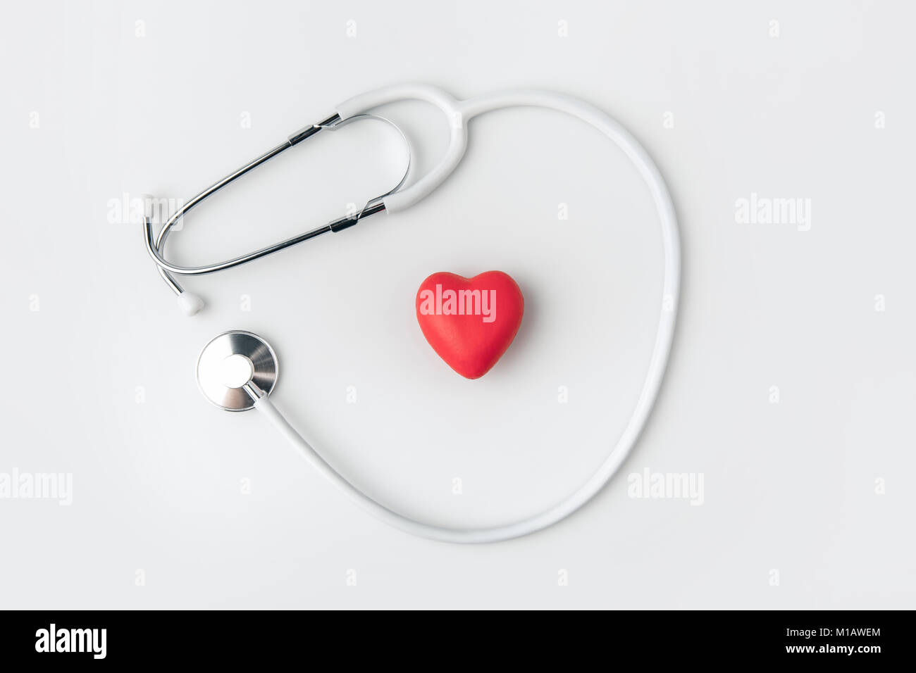 stethoscope with red heart laying isolated on white background Stock ...