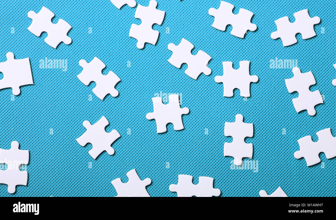 White details of puzzle on background. A puzzle is a puzzle from small ...