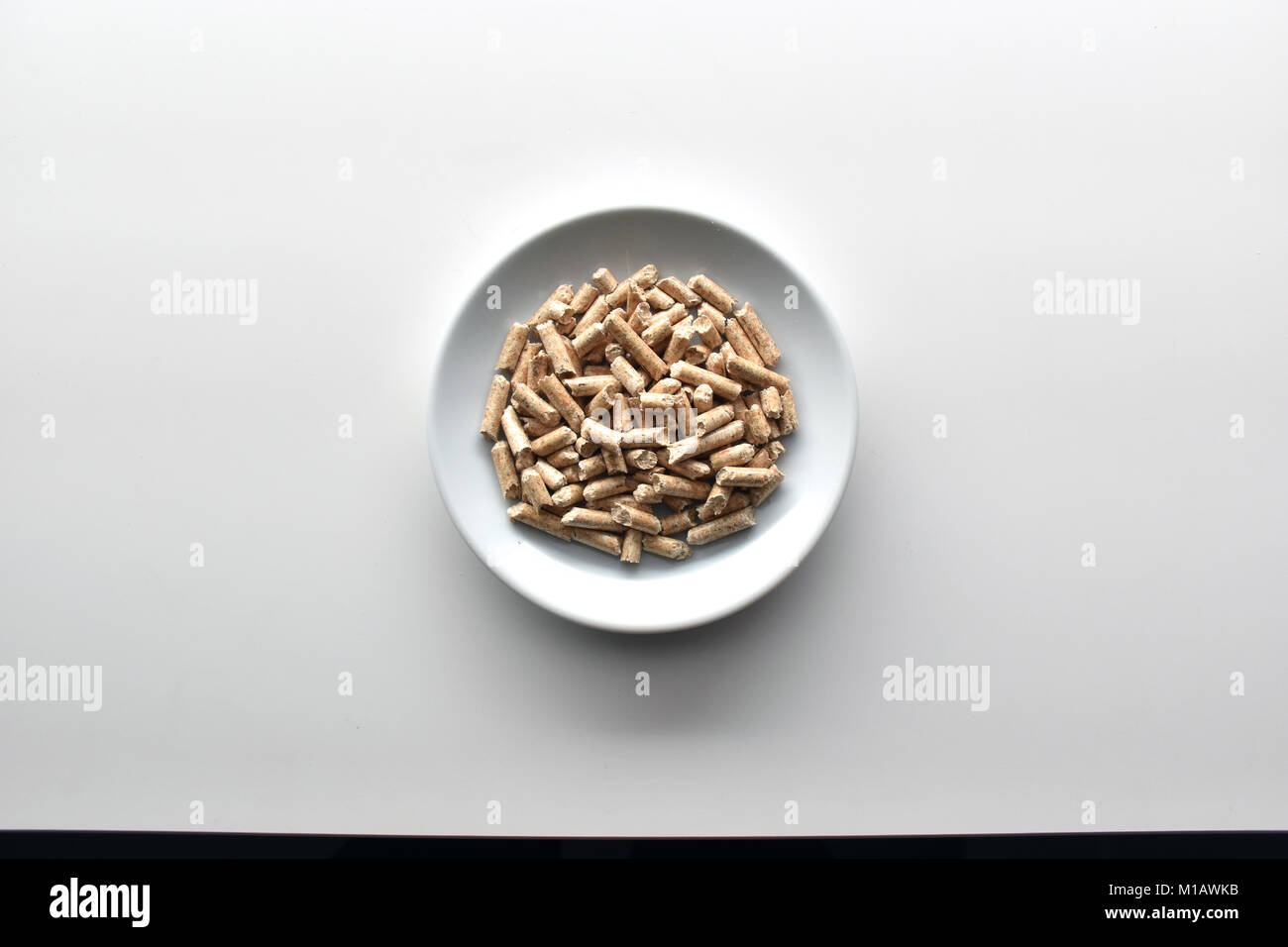 Piles of pellets in the white ceramic plate Stock Photo - Alamy