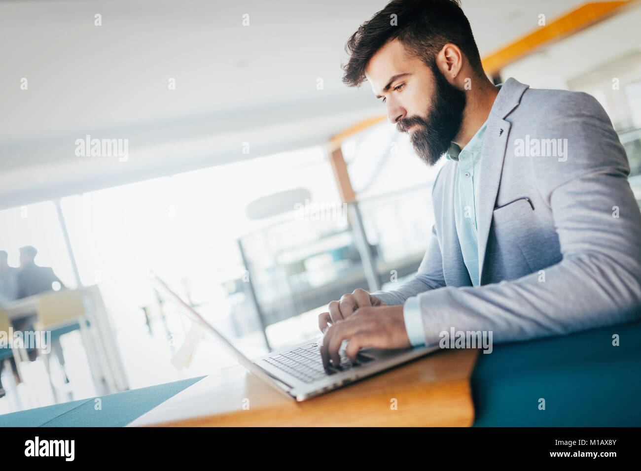 Young employee working on computer during working day in office Stock ...