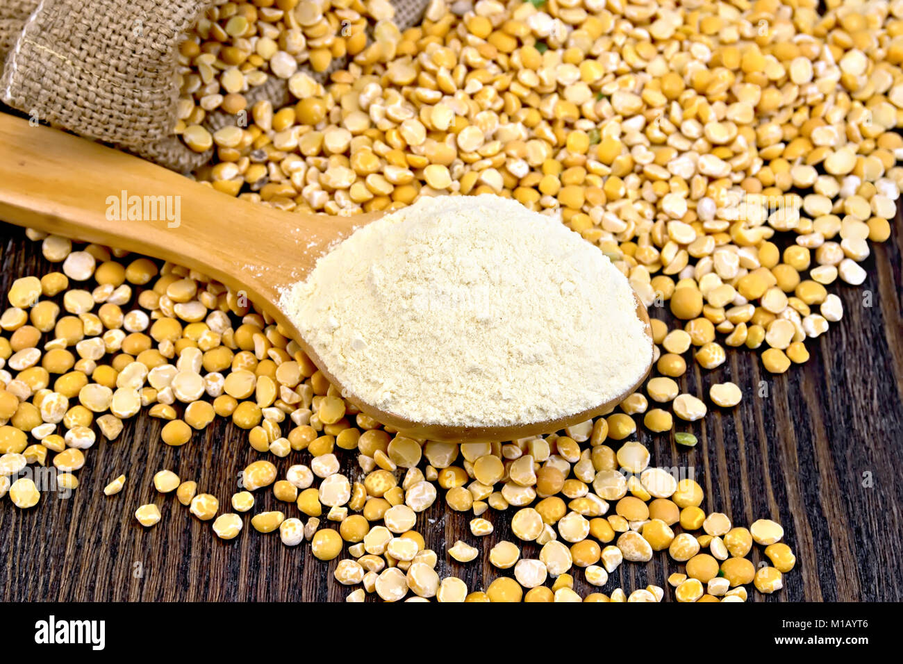 Flour pea in a spoon, split pease on a wooden boards background Stock ...