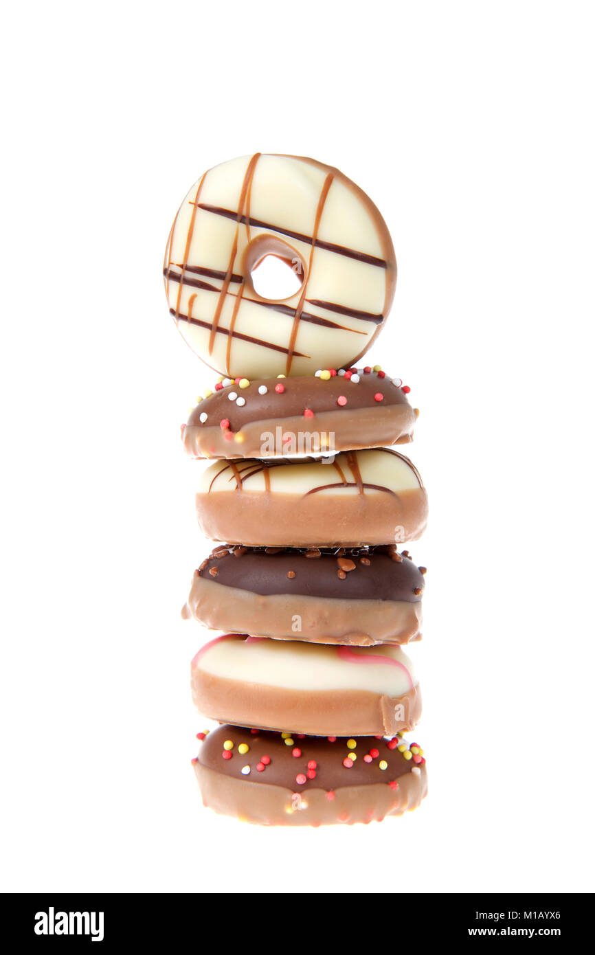 Miniature candy coated donuts decorated, in a single stack isolated on ...