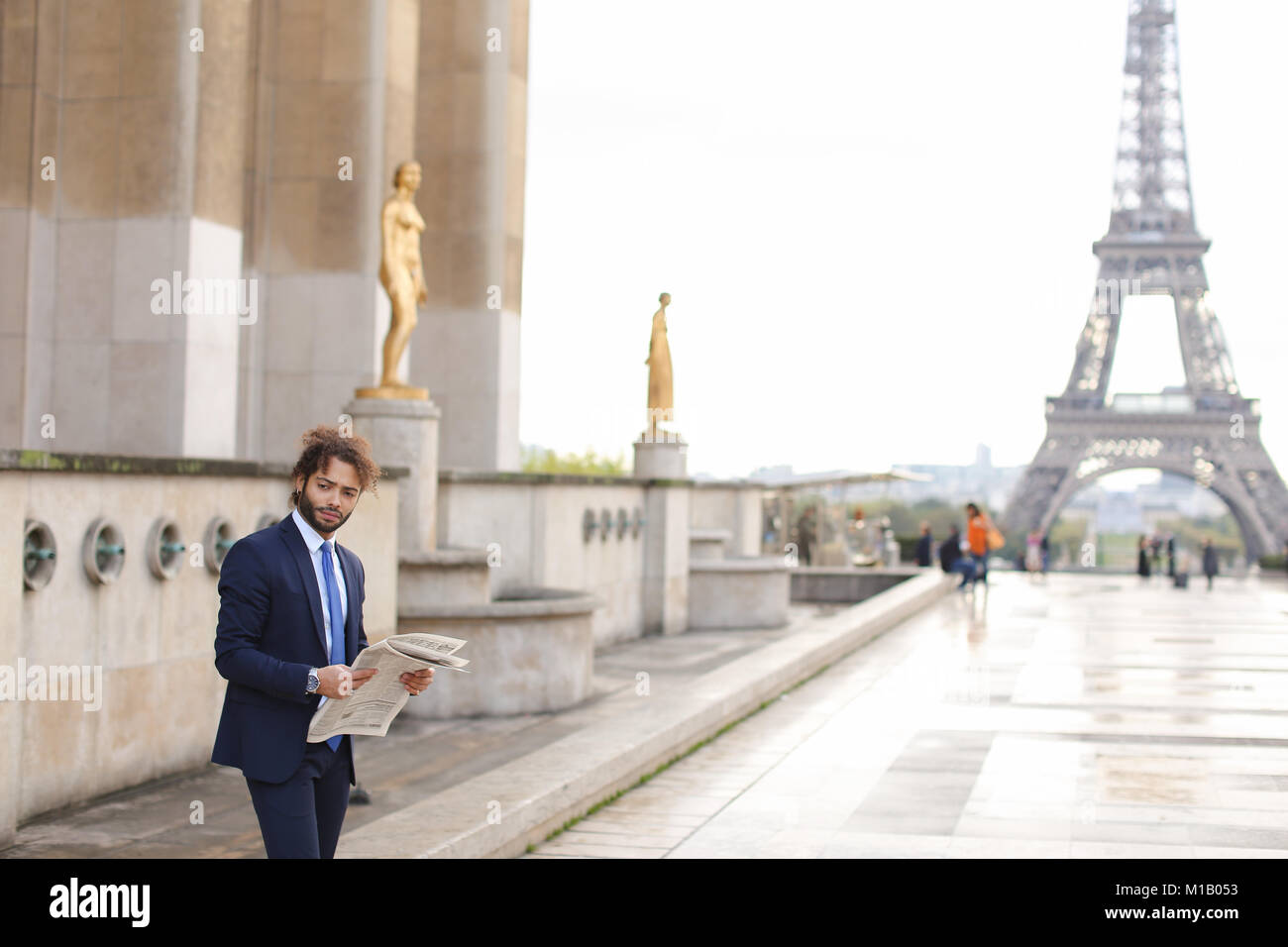 Hispanic journalist close to Eiffel Tower reading newspaper and Stock ...