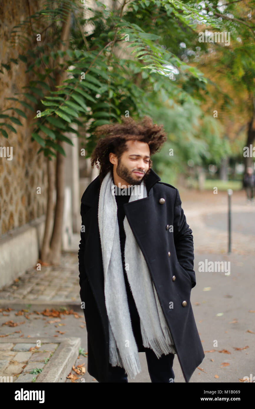 Young mix blood male person walking outside Stock Photo - Alamy