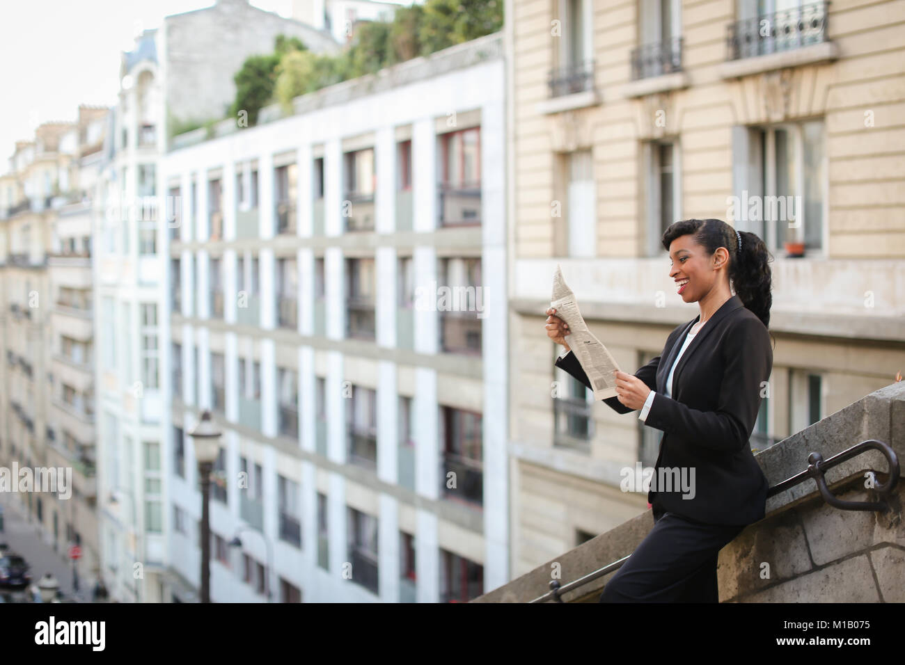 journalist reading newspaper near high building Stock Photo - Alamy