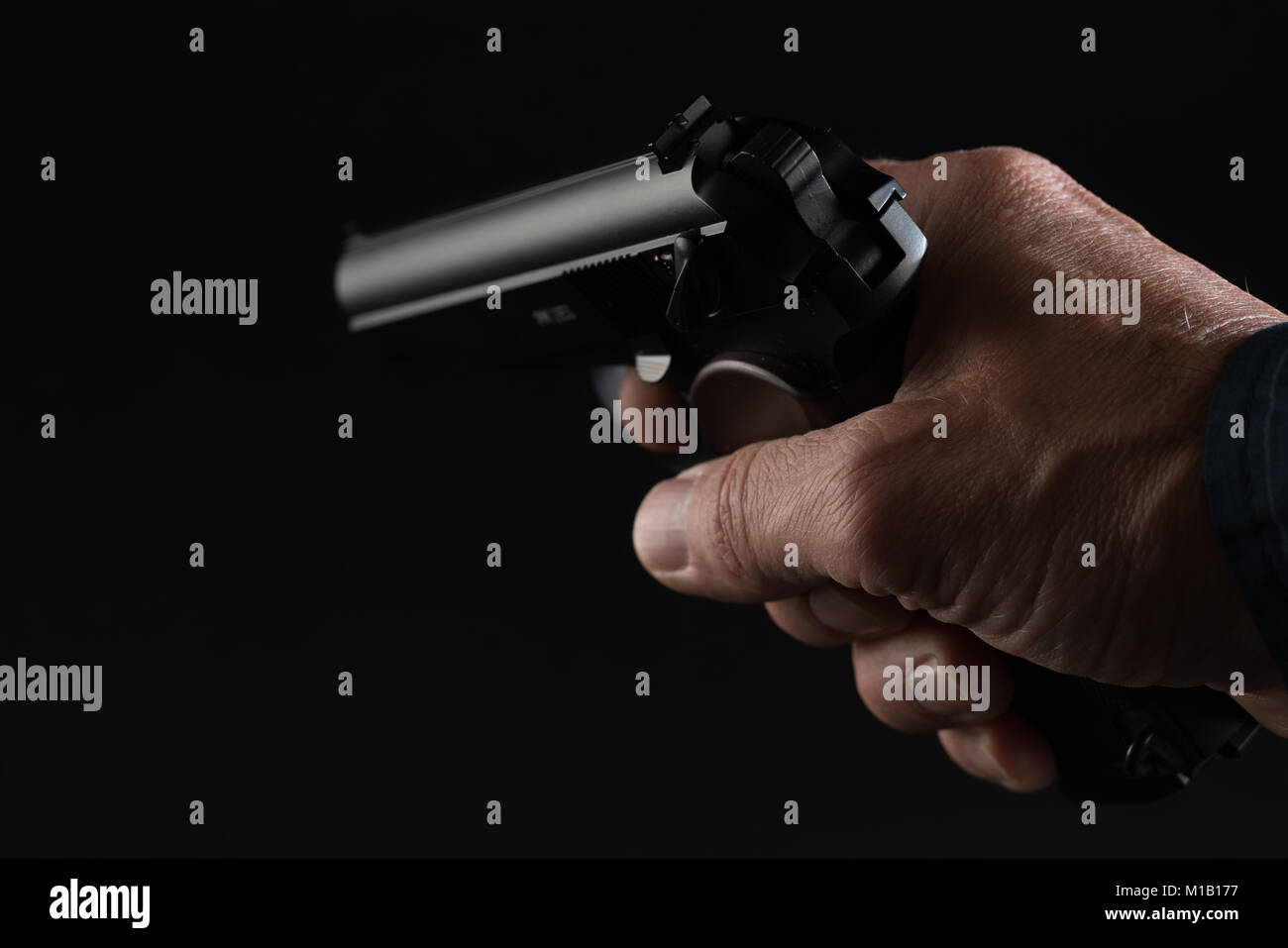 Male hand with gun Stock Photo - Alamy