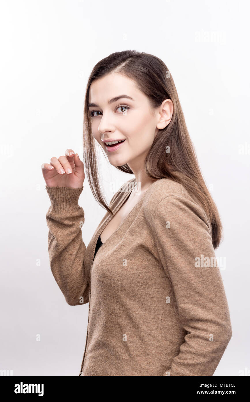 Cheerful woman posing half-turned and chuckling Stock Photo - Alamy