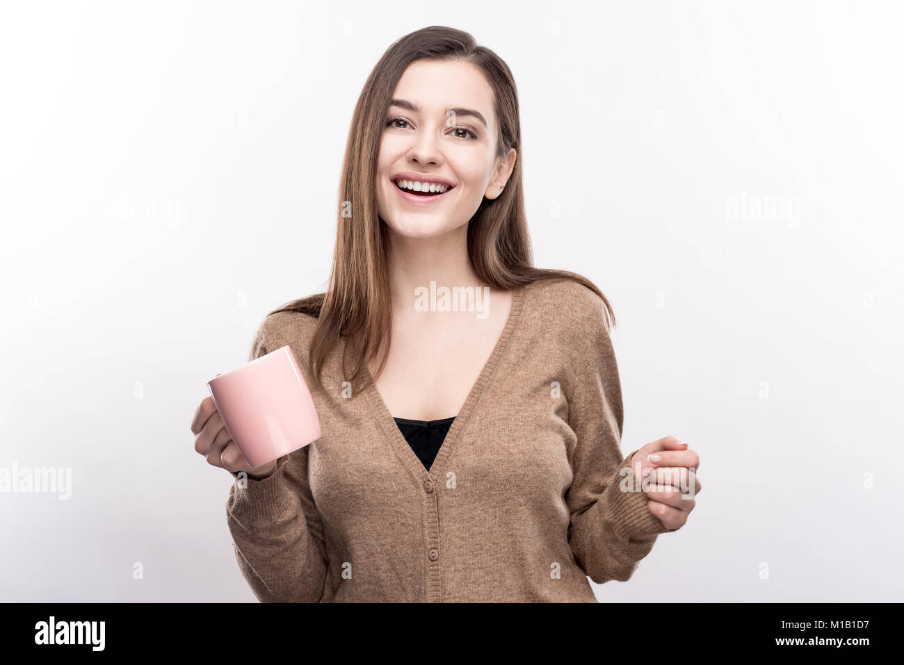 Adorable young woman posing with tea cup Stock Photo - Alamy