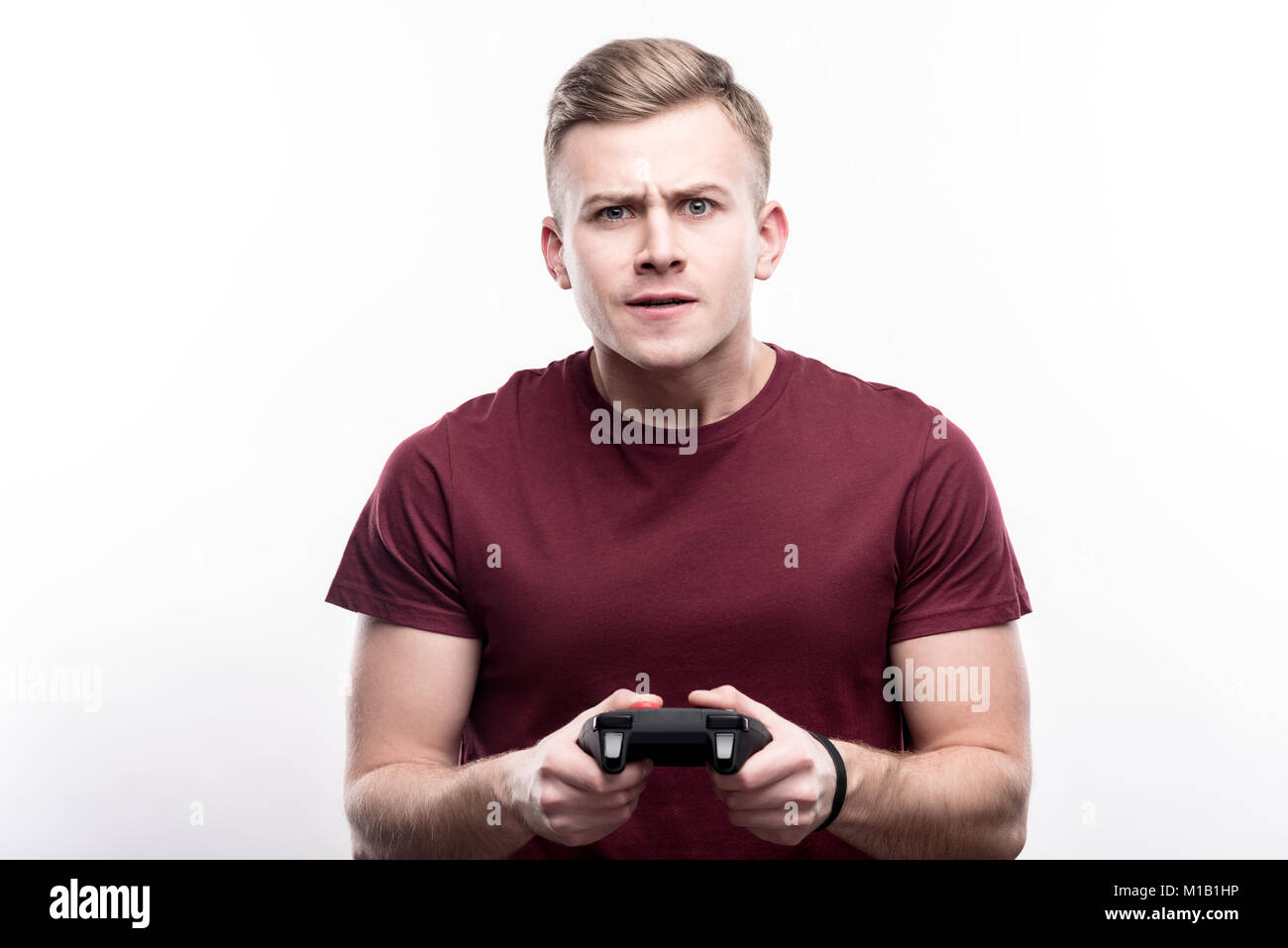 Handsome fair-haired man playing video games Stock Photo - Alamy