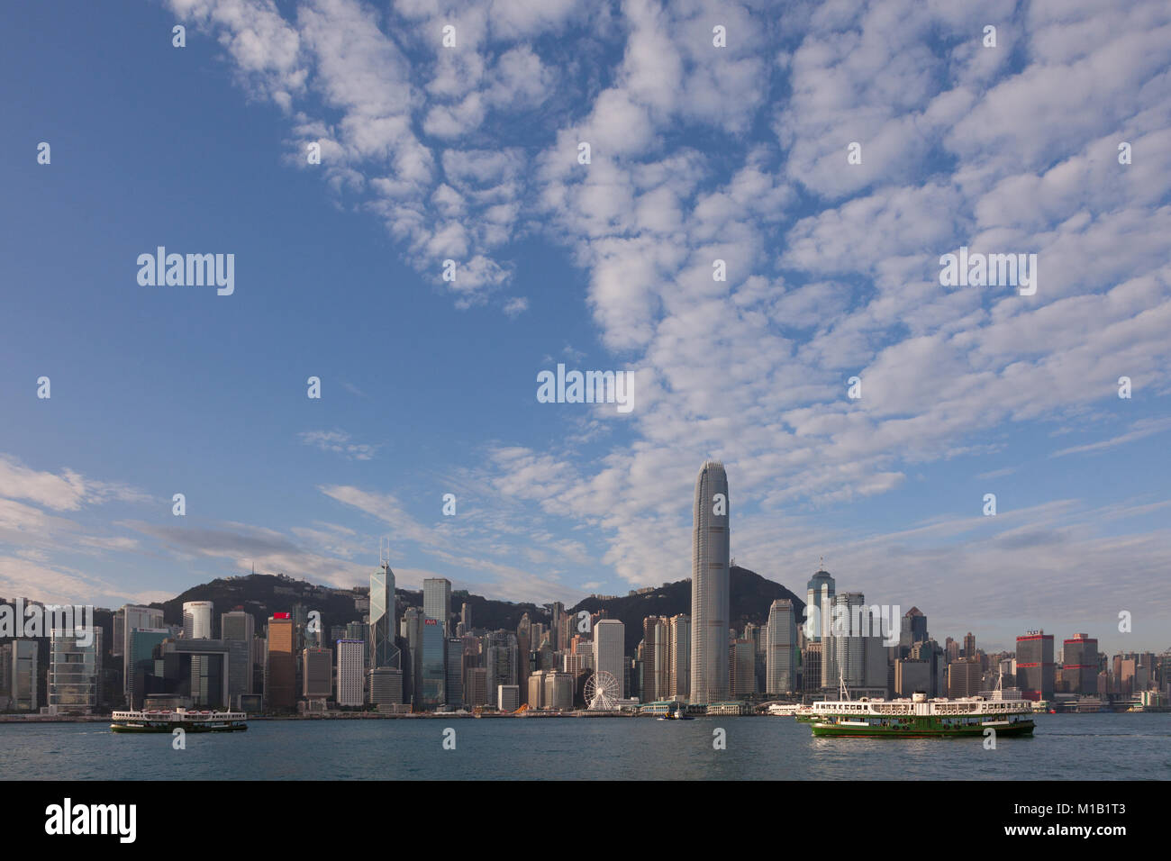 Star Ferries crossing Victoria Harbour in front of the International ...