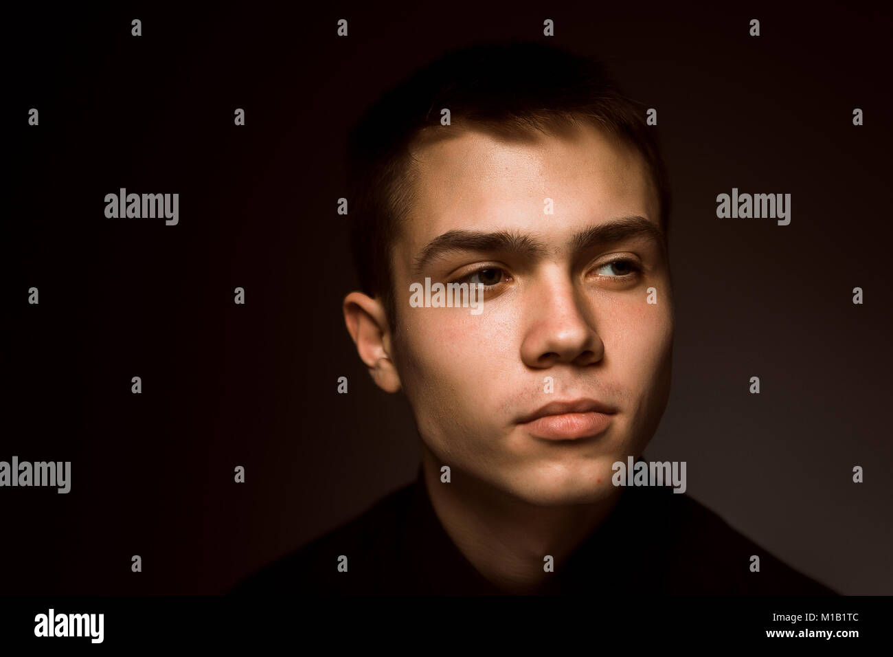 young guy on a dark studio background Stock Photo - Alamy