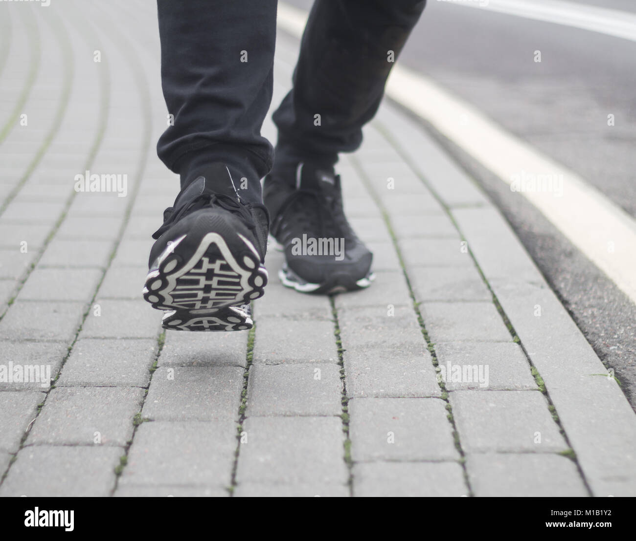feet of people walking on the pavement in winter Stock Photo - Alamy