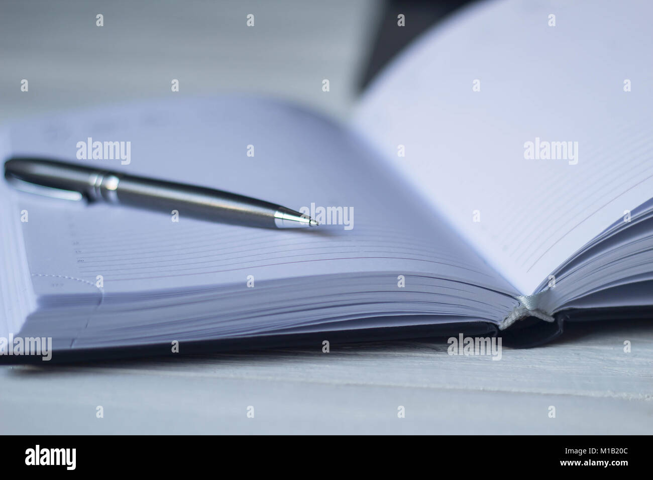 pen and a notebook at the workplace Stock Photo - Alamy