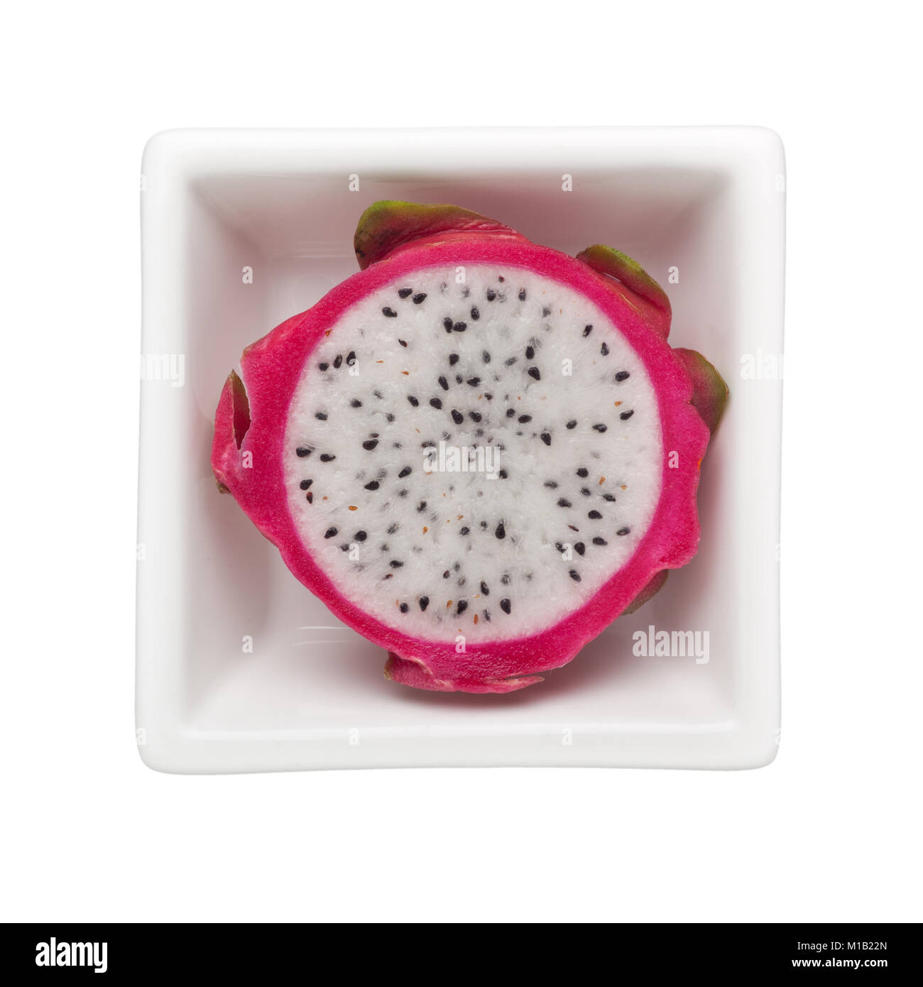 Cut pitaya fruit in a square bowl isolated on white background Stock ...