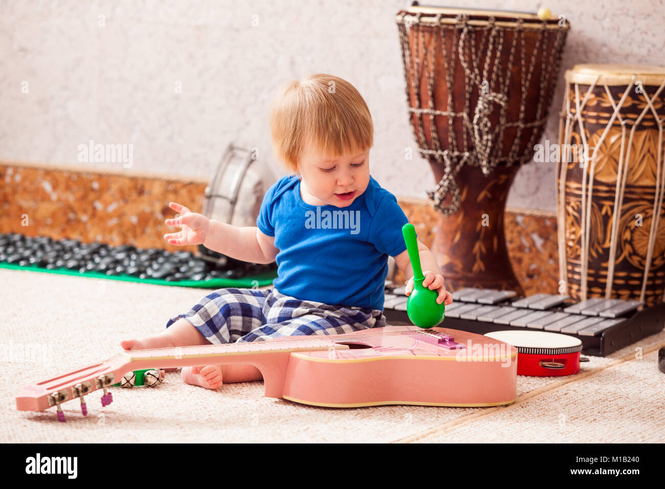 Boy with musical instruments Stock Photo - Alamy