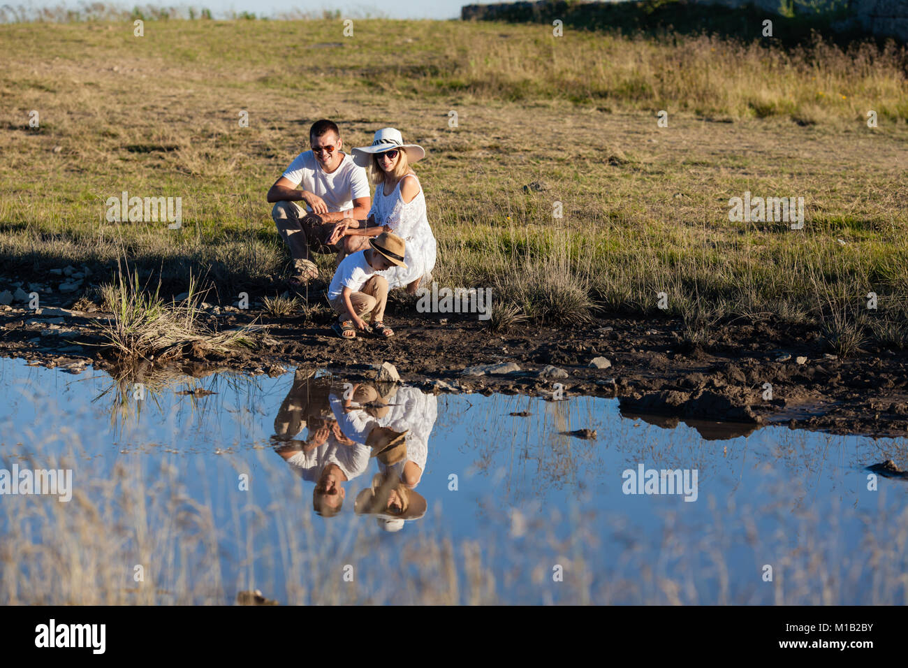 Family walk near the pond Stock Photo - Alamy