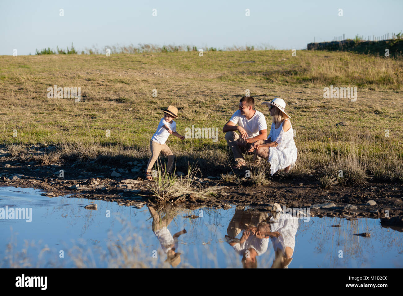 Family walk near the pond Stock Photo - Alamy