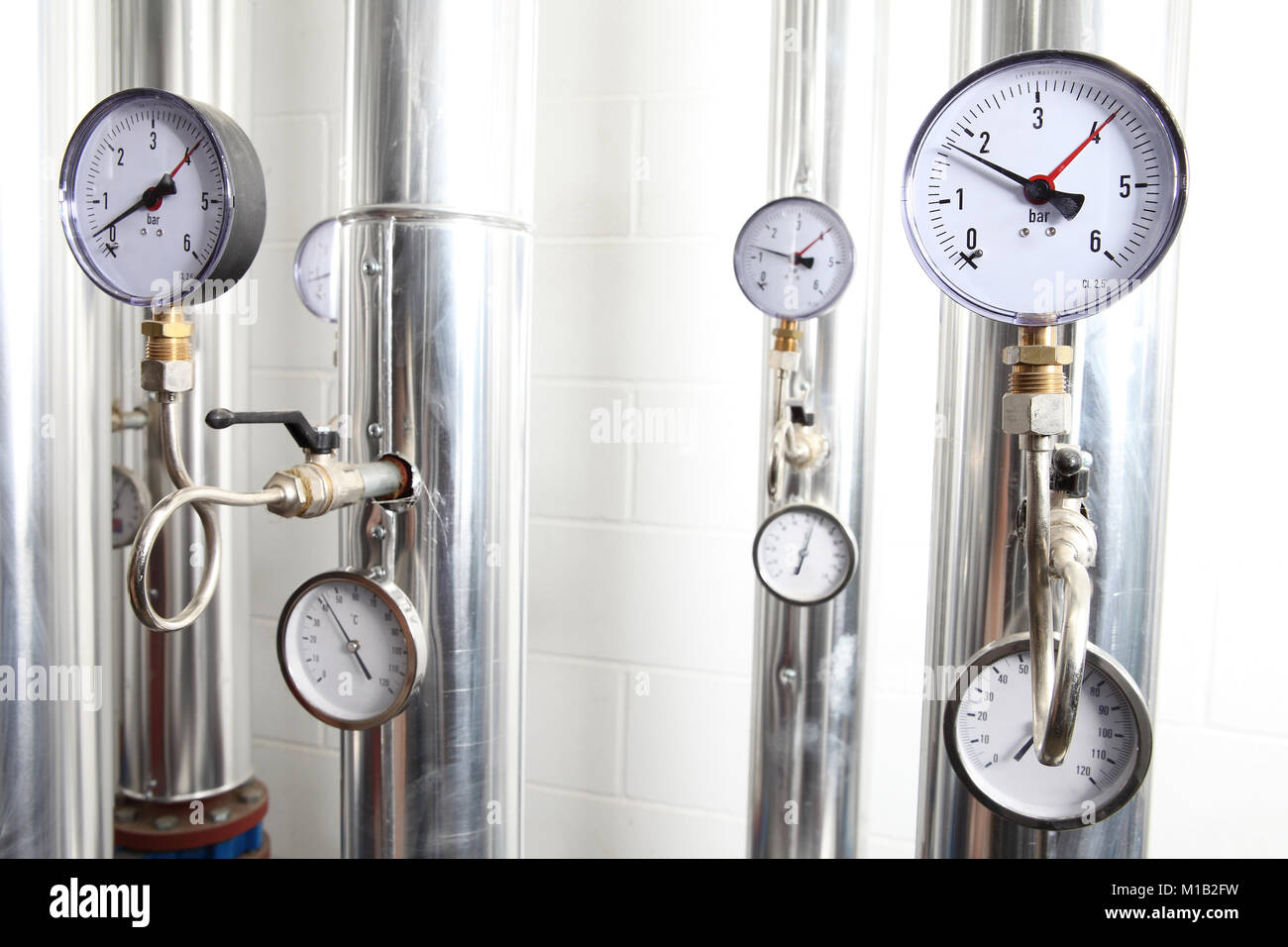 manometer, pipes and faucet valves of heating system in a boiler room ...