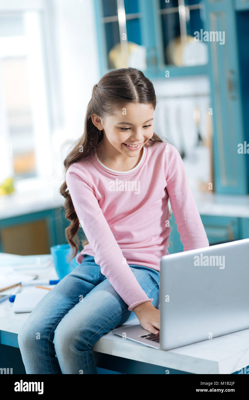 Content schoolgirl working on her laptop Stock Photo - Alamy