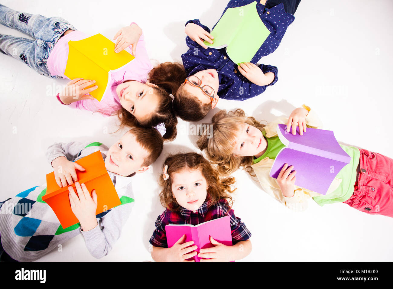 The cute children with books Stock Photo - Alamy