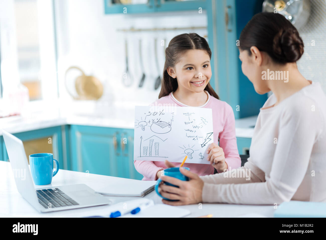 Exuberant child showing a sheet of paper Stock Photo - Alamy