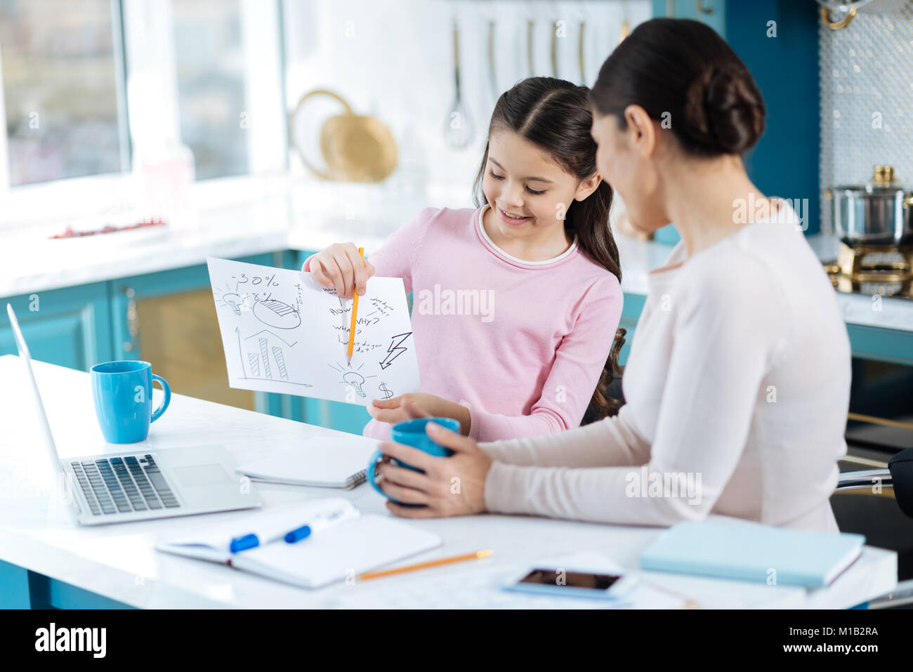 Inspired child showing a sheet of paper Stock Photo - Alamy