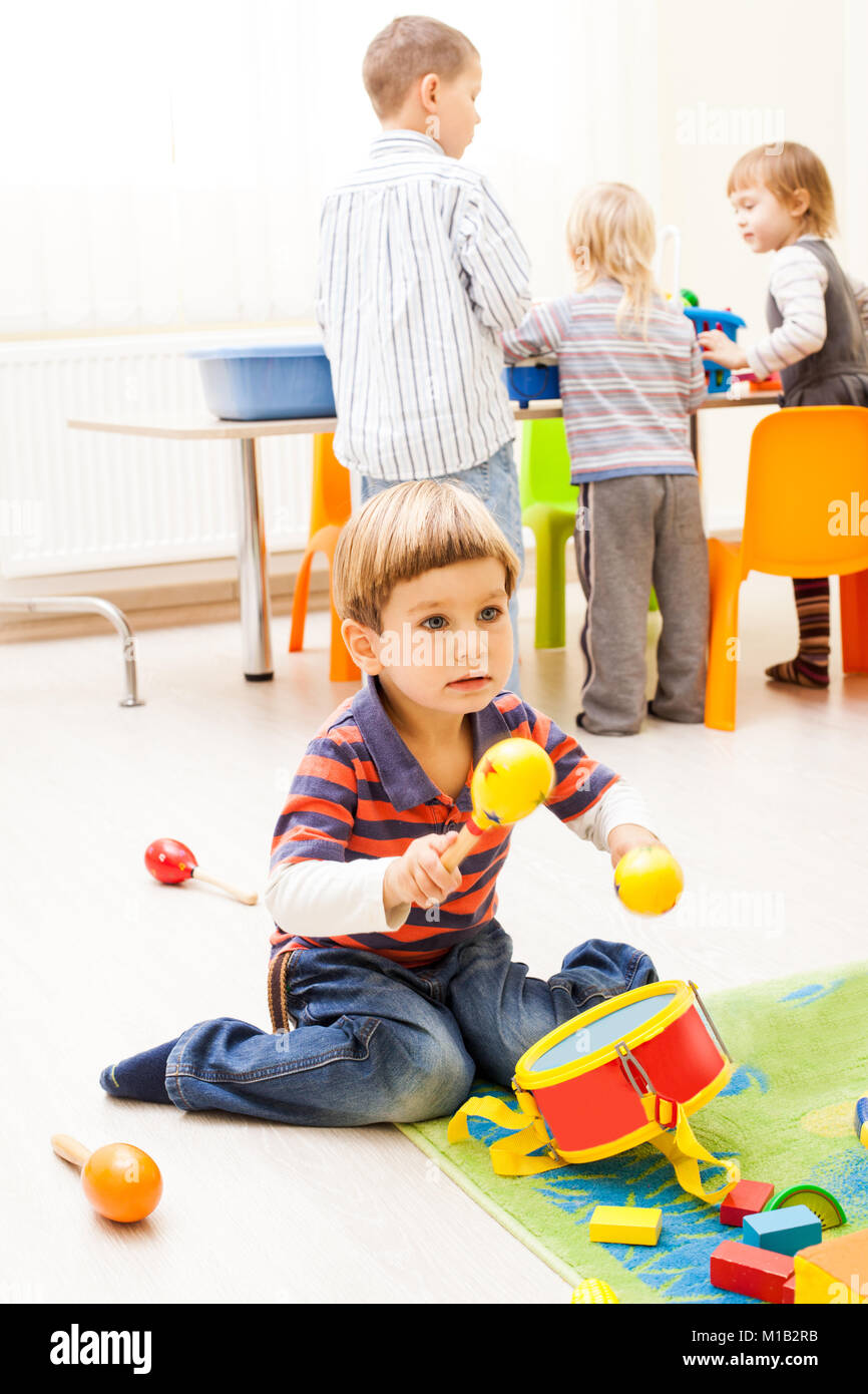 Kids playing with toys Stock Photo - Alamy