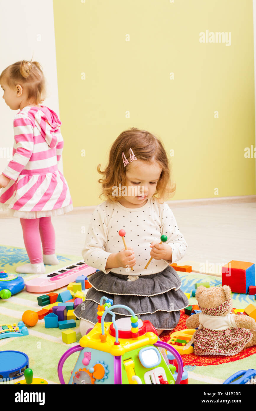 Kids playing with toys Stock Photo - Alamy