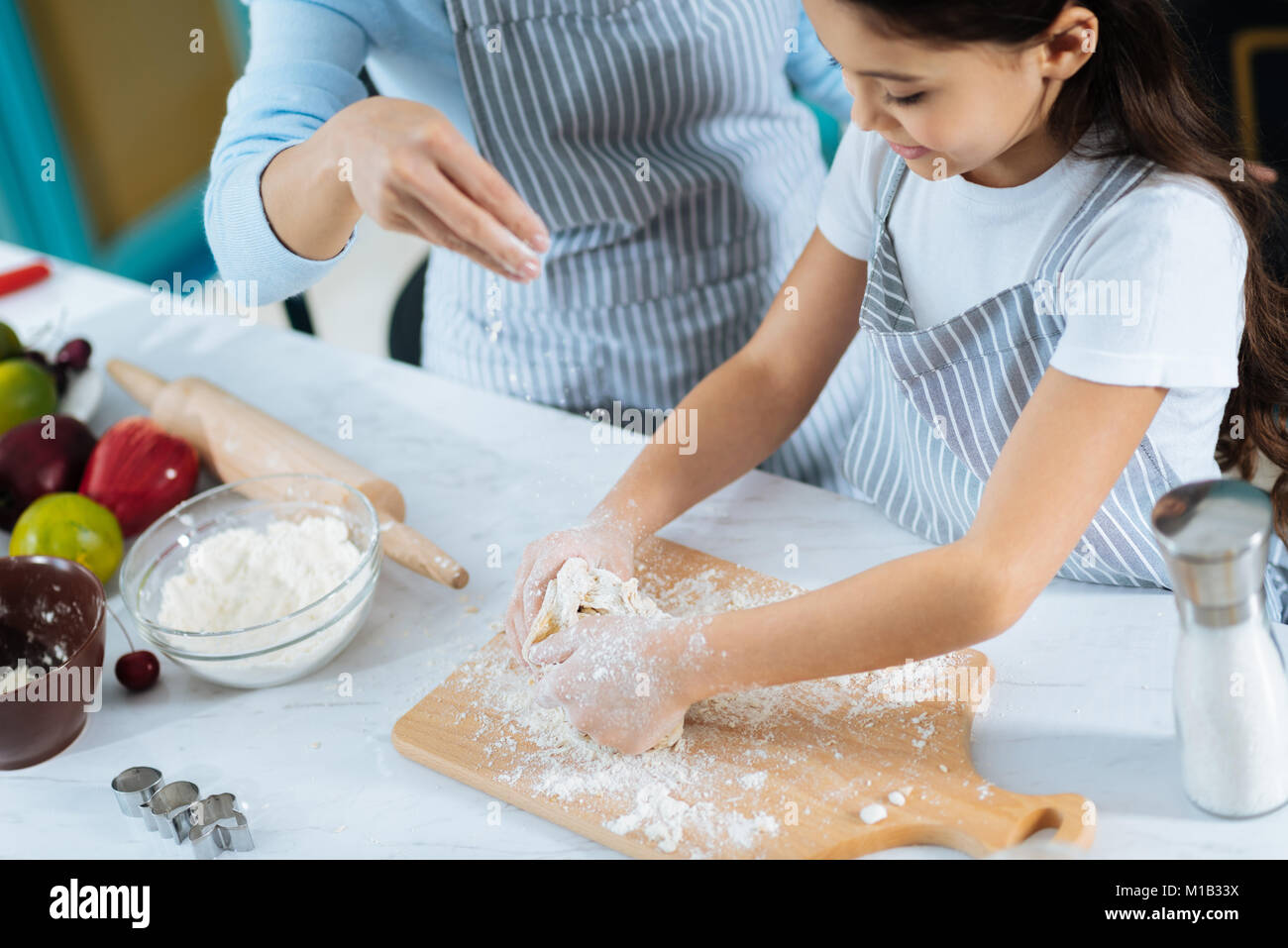 Little lovely girl cooking with her mom Stock Photo - Alamy