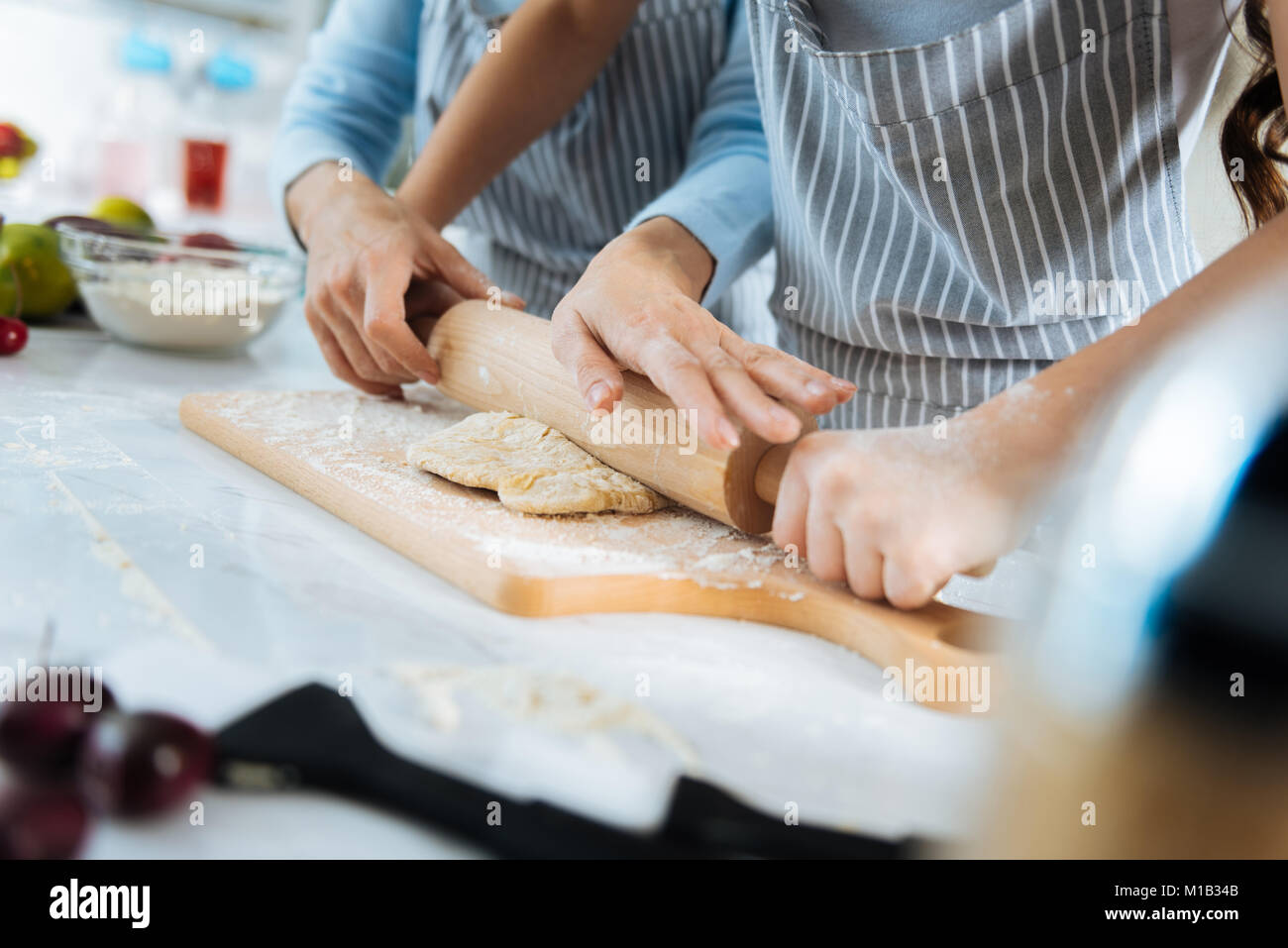 Devoted mother helping her daughter Stock Photo - Alamy