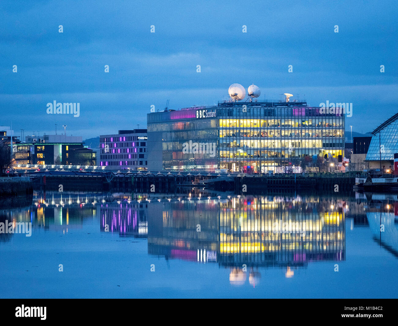 Evening view of BBC Scotland headquarters reflected in River Clyde in ...