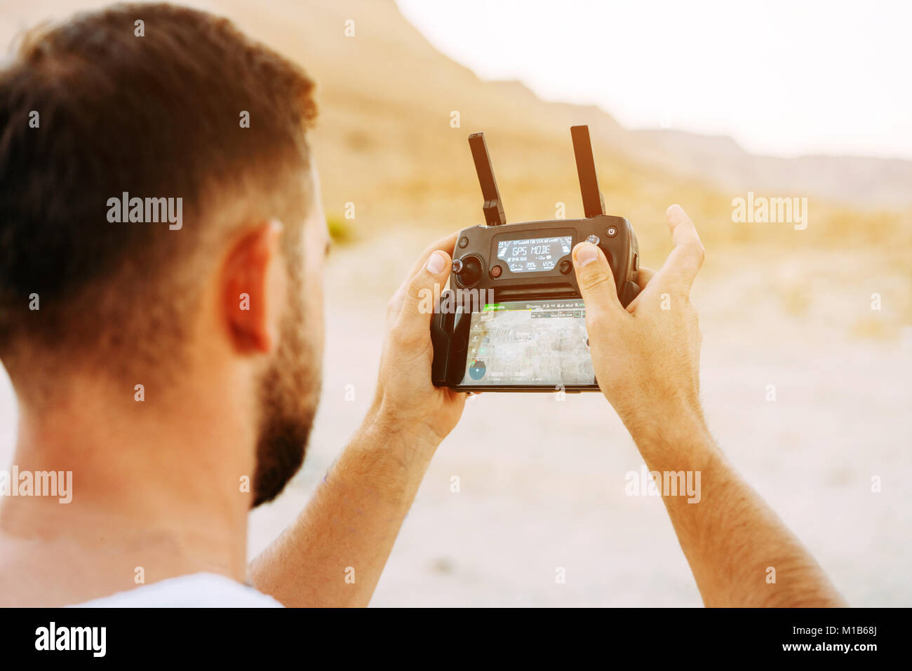 Guy controls drone with remote control Stock Photo - Alamy