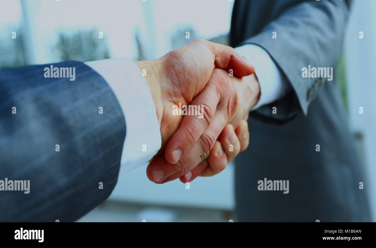 Two businessman shaking hands Stock Photo - Alamy