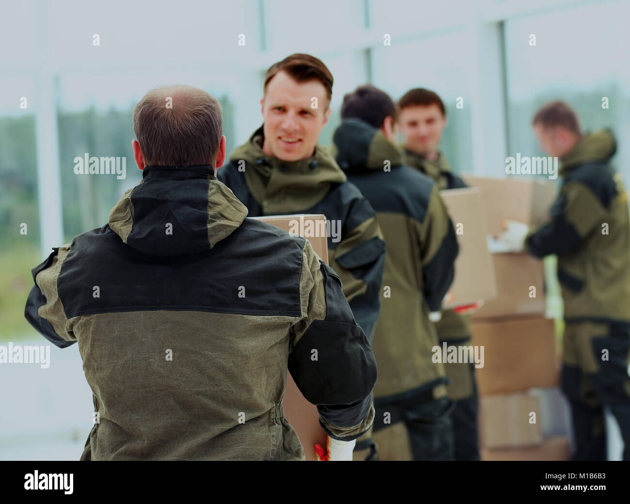 workers unload boxes Stock Photo - Alamy