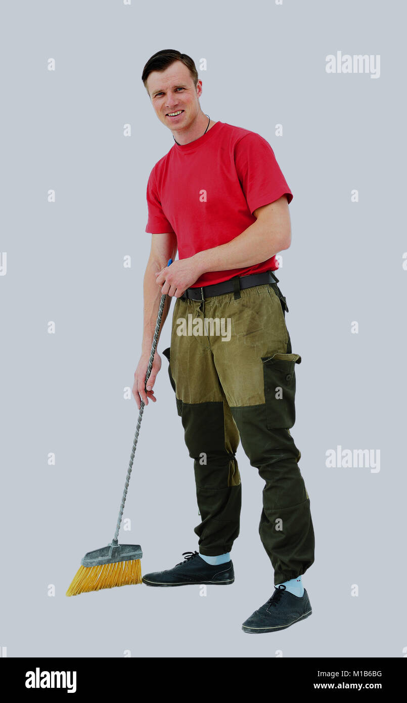 Full length portrait of a cleaner in a uniform with a broom isolated ...