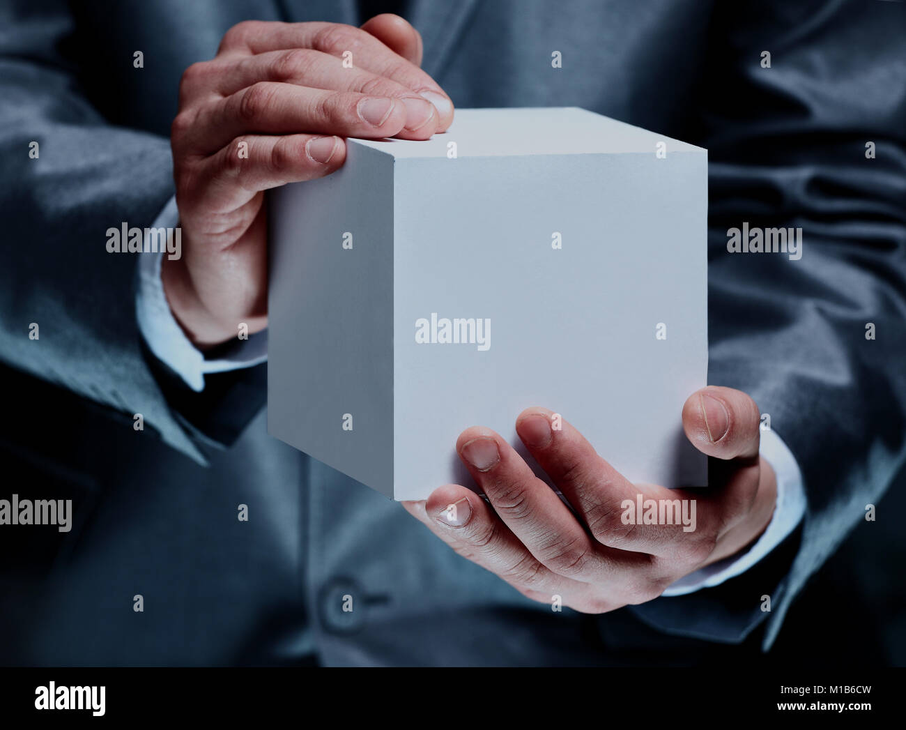 Cube in the male hands Stock Photo - Alamy