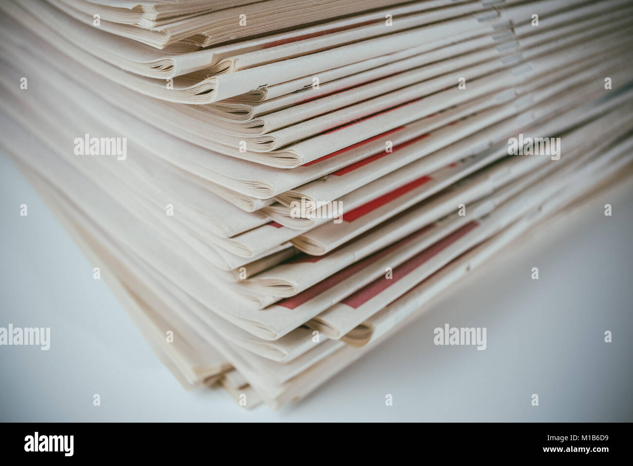 Stack of newspapers placed on white background Stock Photo - Alamy