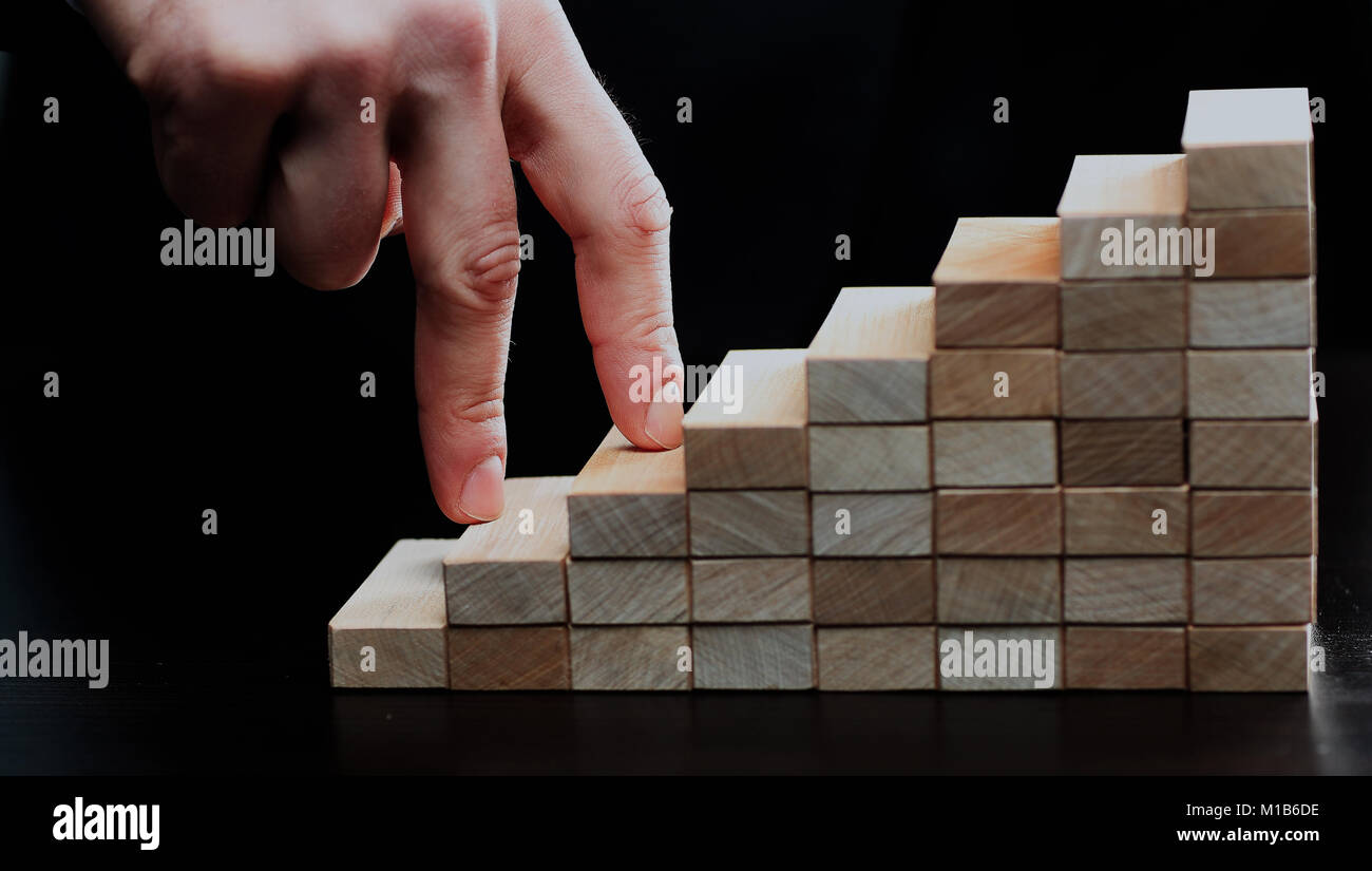Hand climbing stairs made by wooden blocks Stock Photo - Alamy