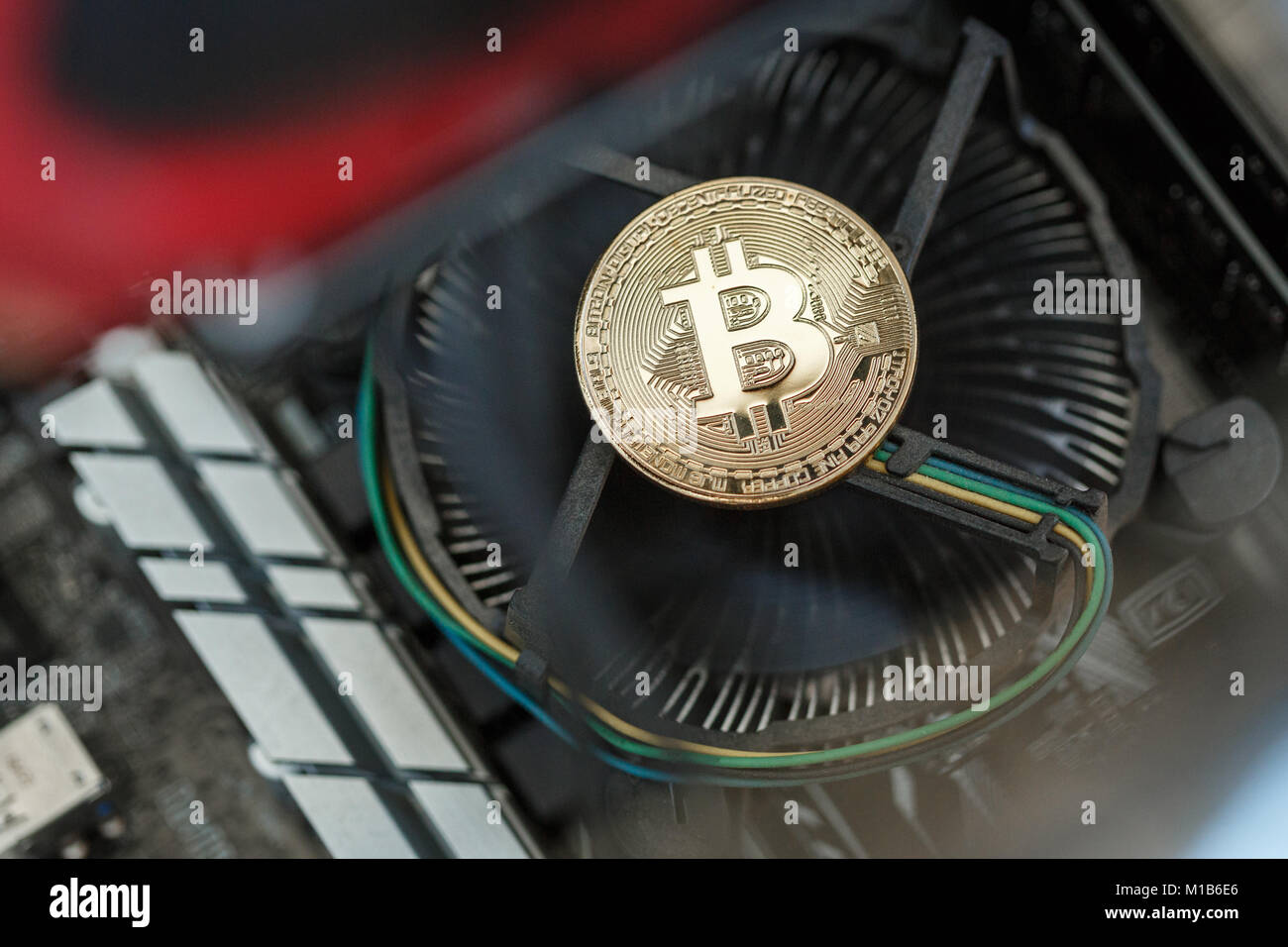 Golden metal coin as symbolic version of Bitcoin on a background of ...