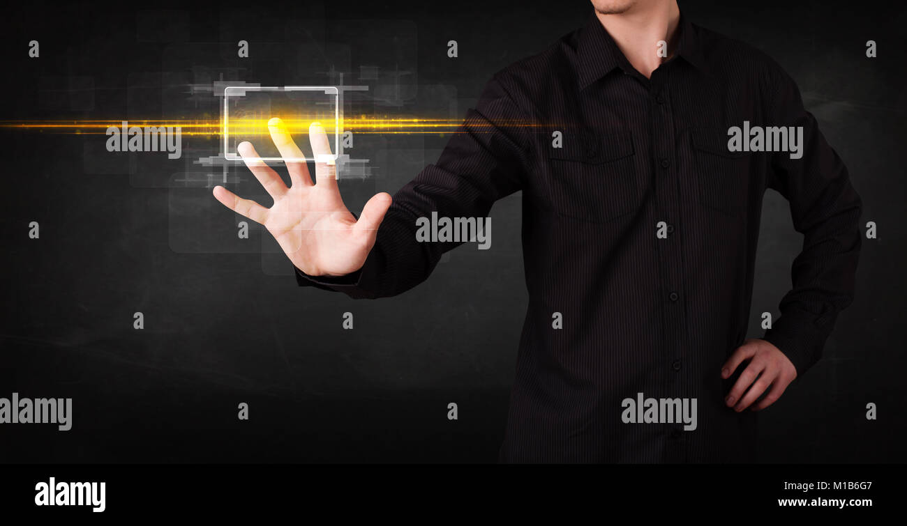 Tech person touching button with orange light beams concept Stock Photo ...