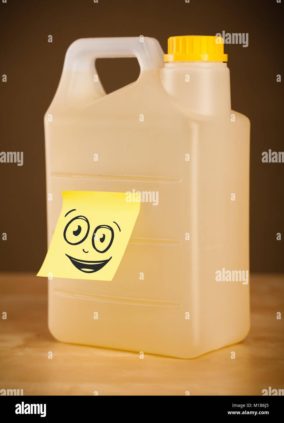 Drawn smiley face on a post-it note sticked on a can Stock Photo - Alamy