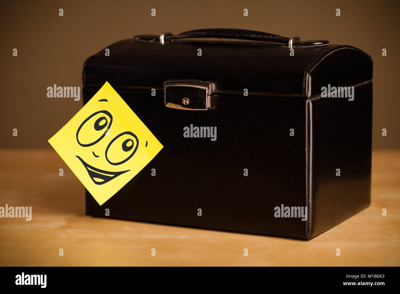 Drawn smiley face on a post-it note sticked on a jewelry box Stock ...