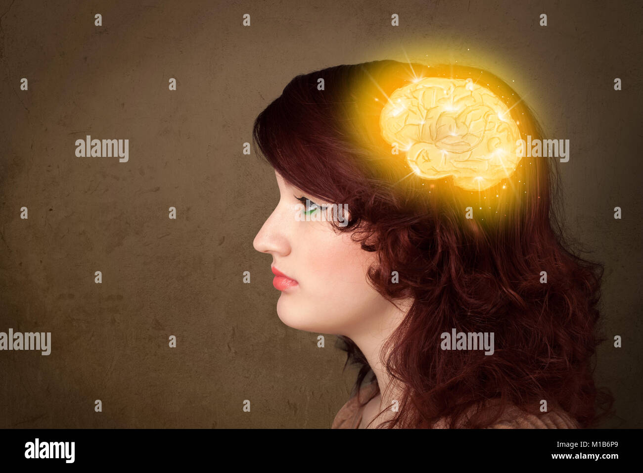 Young girl thinking with glowing brain illustration on grungy ...