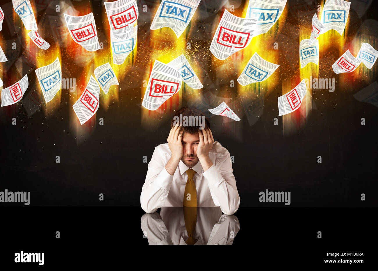 Depressed businessman sitting under falling papers Stock Photo - Alamy