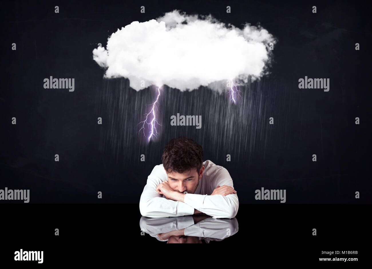 Depressed businessman sitting under a lightning rainy cloud Stock Photo ...