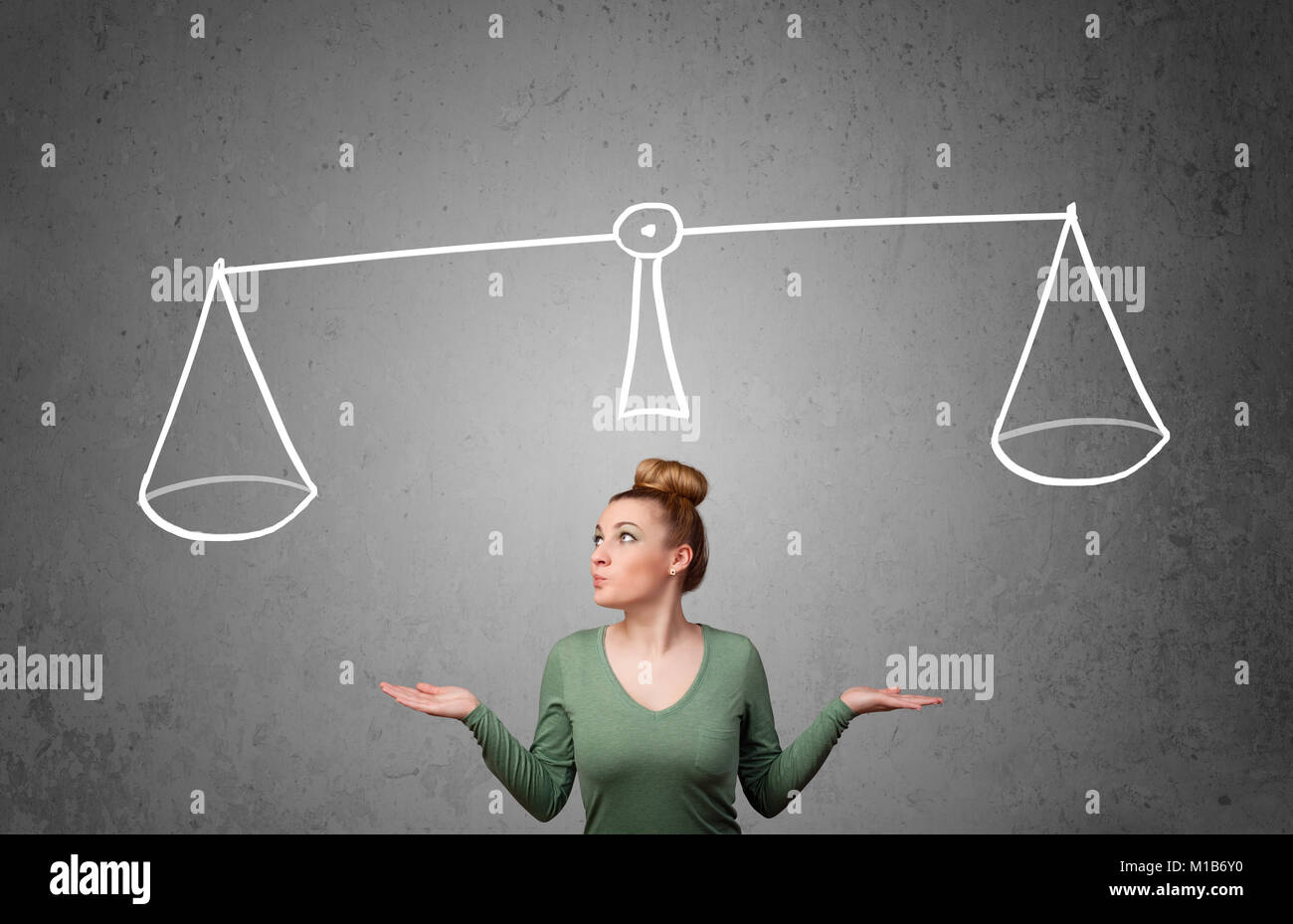 Pretty young lady taking a decision with scale above her head Stock ...