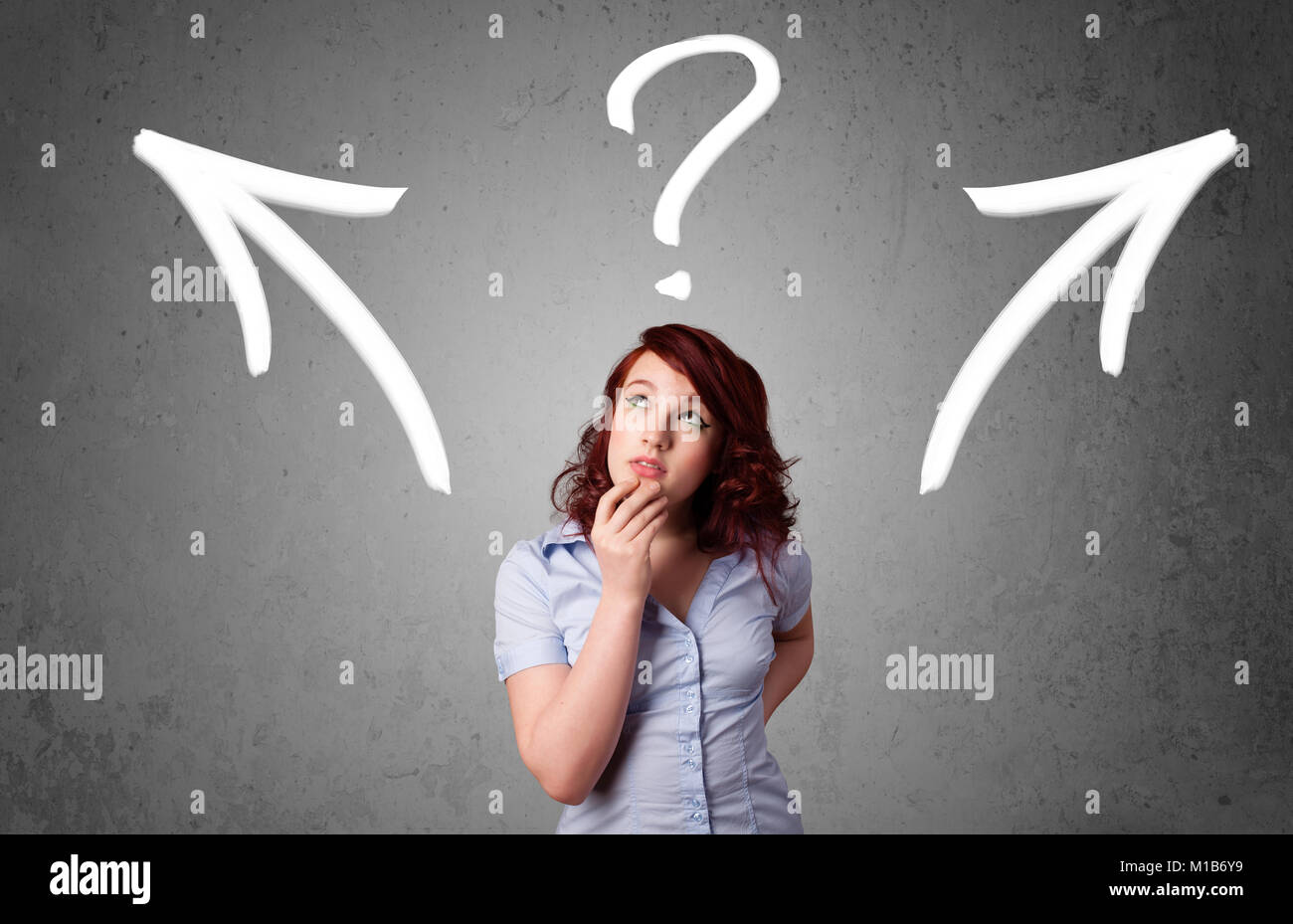 Pretty young woman making a decision with arrows and question mark ...